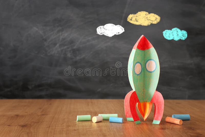 Education and Back To School Concept. Cardboard Rocket and Chalks in ...