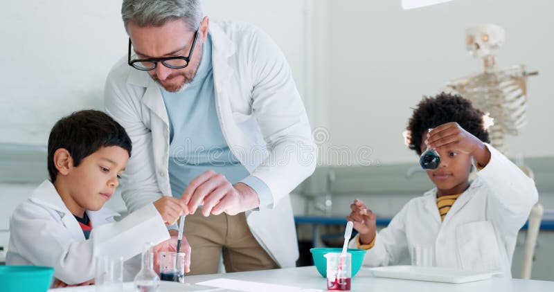 Education, Chemistry and Man Teacher with Children Working on an ...