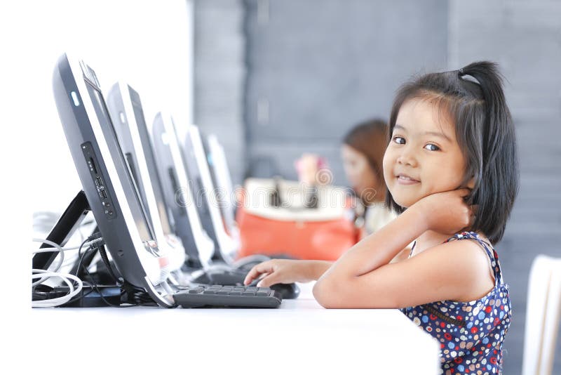 Elementary Students Working at Computers in Classroom Stock Photo ...