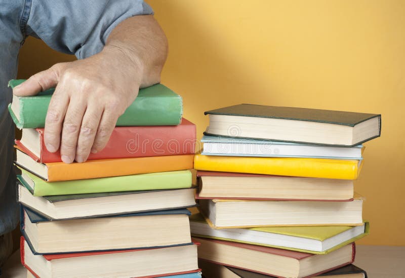 Hand of Man on Stack of Colorful Books. Education Background. Stock ...
