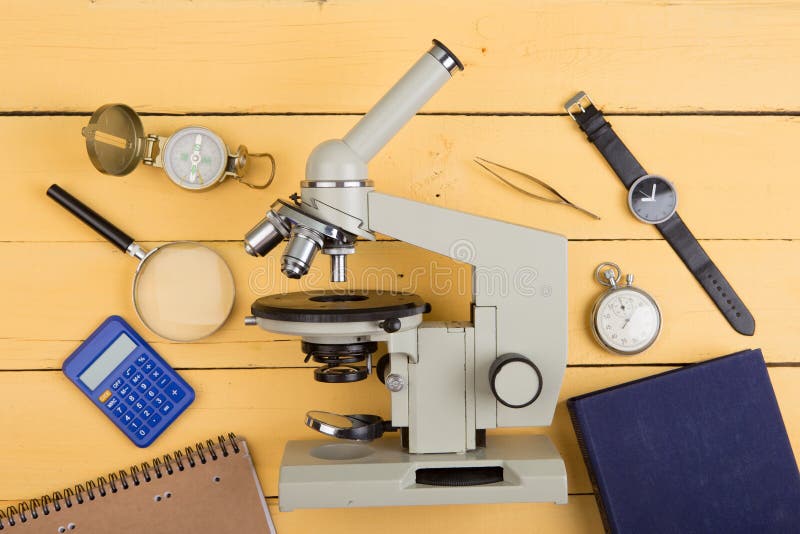 Education Concept - Notepad, Microscope on the Yellow Wooden Desk Stock ...