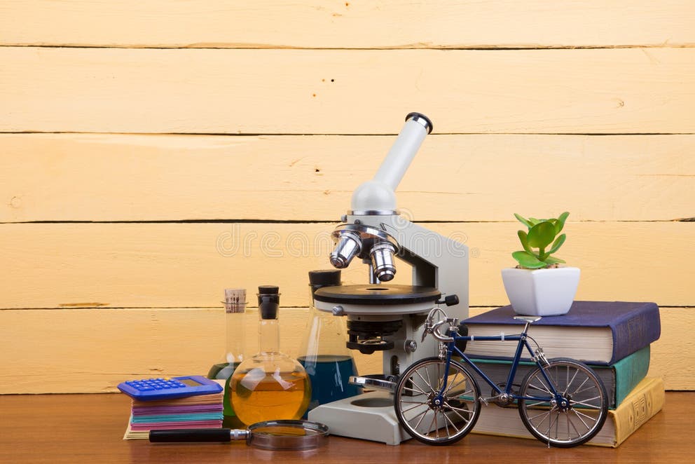 Education Concept - Notepad, Microscope on the Yellow Wooden Desk Stock ...