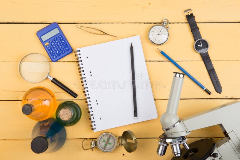 Education Concept - Notepad, Microscope on the Yellow Wooden Desk Stock ...