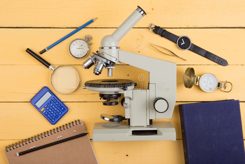 Education Concept - Notepad, Microscope on the Yellow Wooden Desk Stock ...