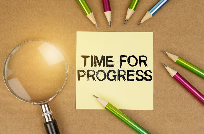 On the Table are Pencils, a Magnifying Glass and a Sticker with the ...