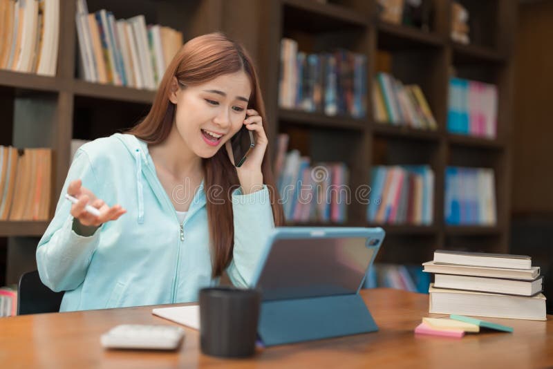 Education Concept, Teenage Girl Talking on Smartphone while Watching ...