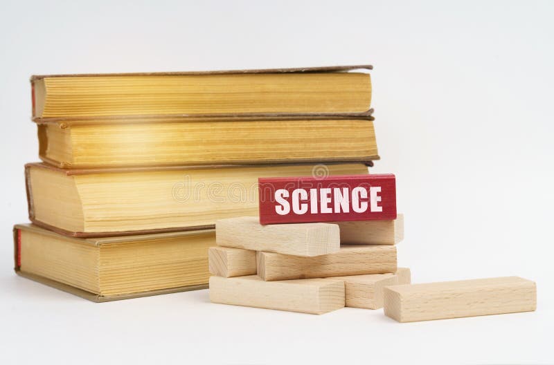 On a White Surface, a Stack of Books and Wooden Blocks, on a Red Block ...
