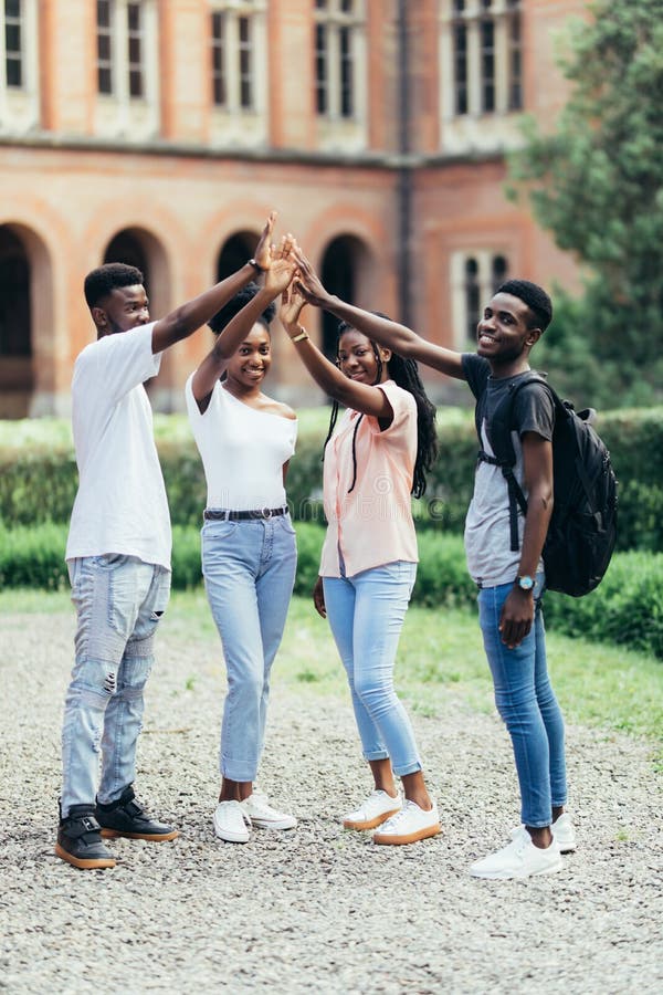 Education and Friendship Concept. Happy Students Giving High Five at ...