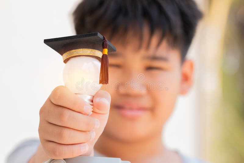 Education or Graduate Study Creative Concept: Asian Boy Holding ...