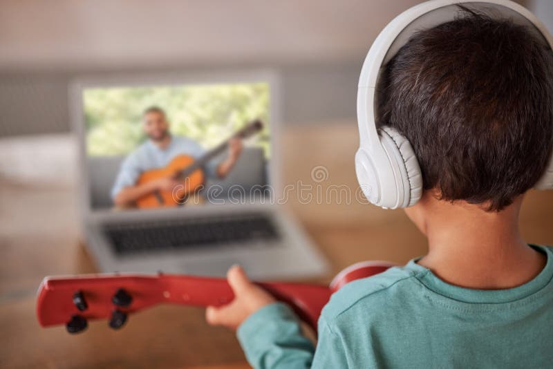Education, Laptop and Child with Guitar Learning How To Play on Remote ...