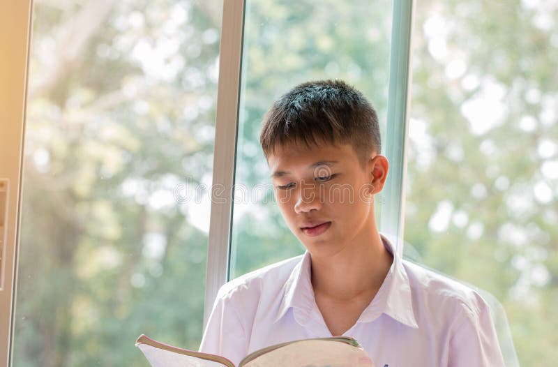 Education Learning Concept: Happy Asian Young Man Student Reading Book ...