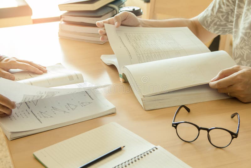 Two Students with Open Book Stock Image - Image of casual, giving: 26516897