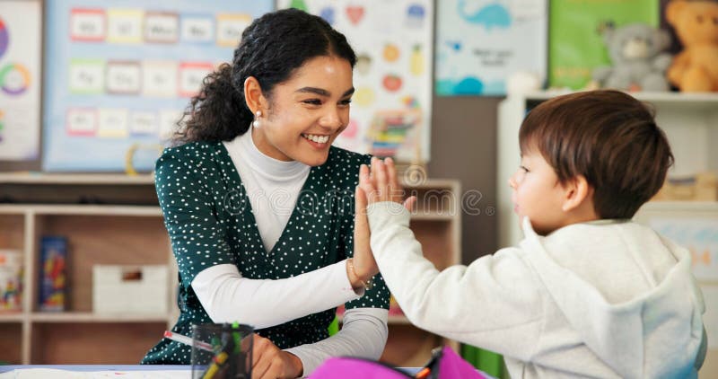 Education, Teacher and Child with High Five in Classroom for Learning Support, Assessment ...