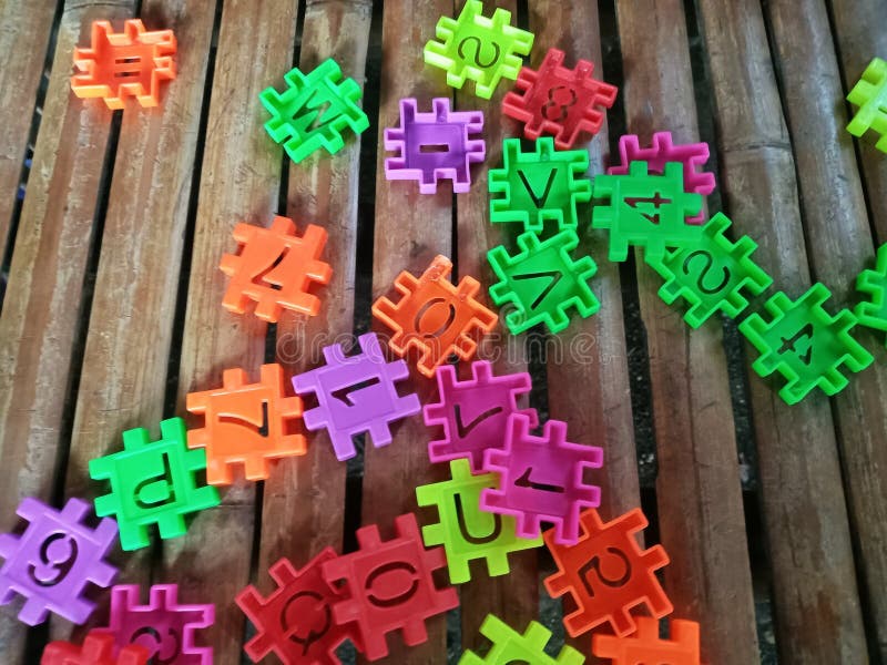 Educational Plastic Puzzle Toy Called Building Blocks on Bamboo Surface ...
