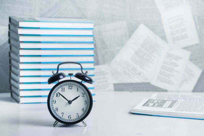 Eduction Concept. Alarm Clock and Book on Reading Table Stock Photo ...