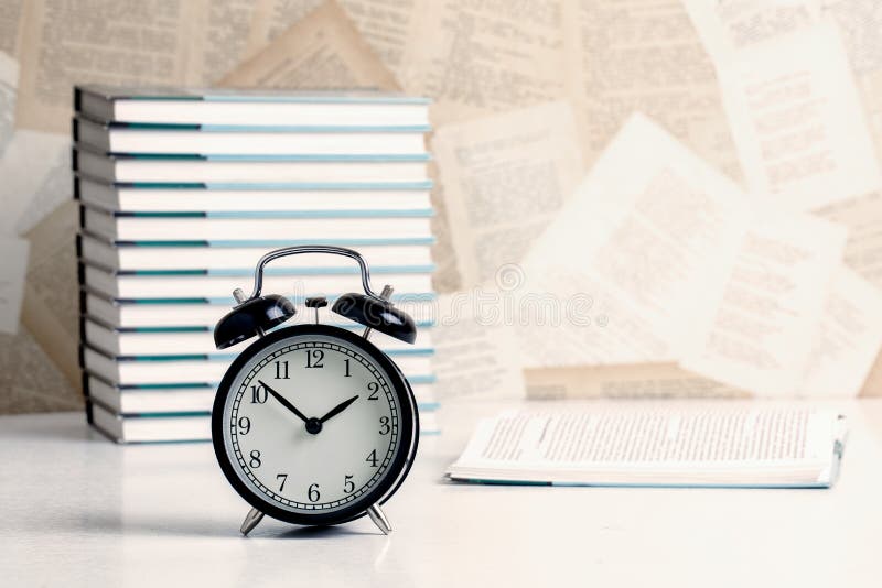 Eduction Concept. Alarm Clock and Book on Reading Table Stock Image ...