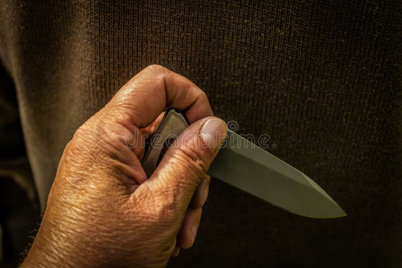 Een Scherp Knipmes in Rug Van a Bemant Achtergedeelte Stock Foto ...