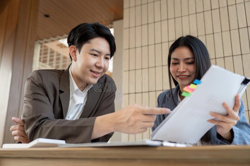 Effective Teamwork. Two Individuals Collaborating on Project Details in ...