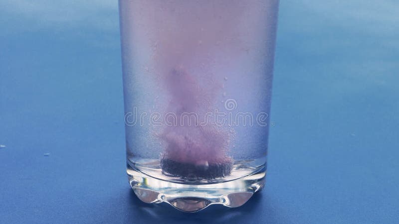 Effervescent Tablet Dissolving in a Glass of Water, Large Bubbles Stock ...