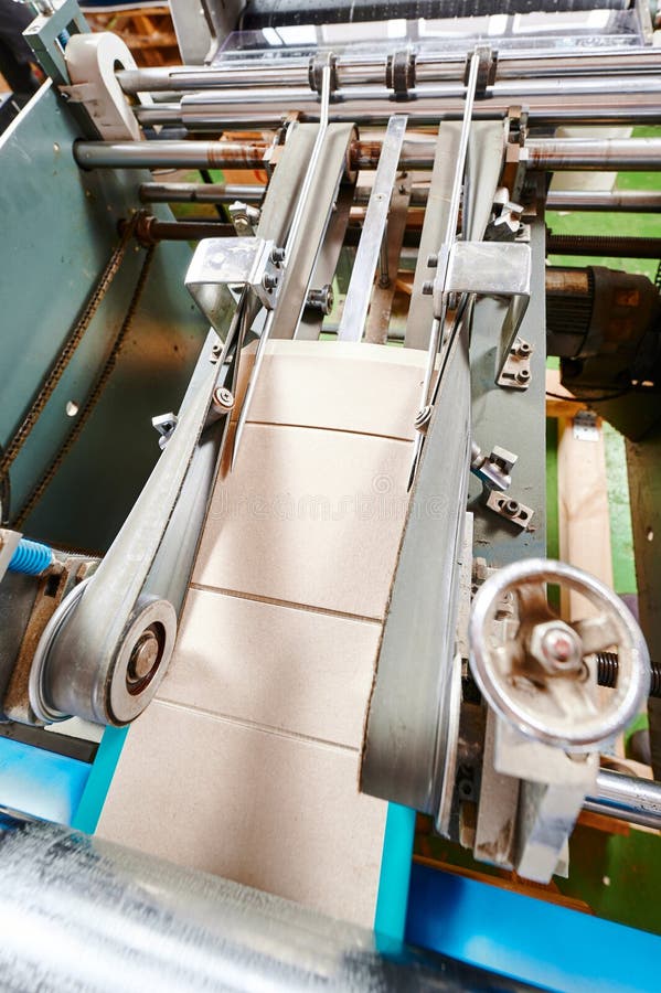 Efficient Cardboard Box Flap Folding Machine in Action at a Bustling ...