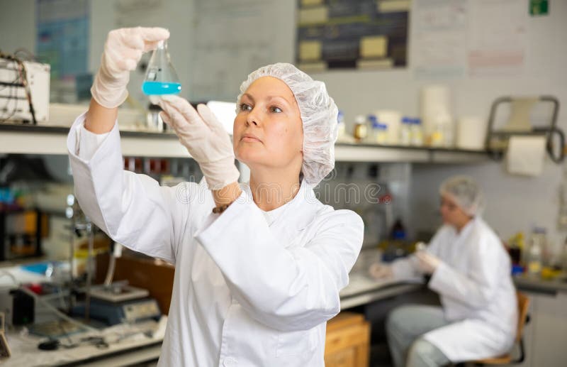 Efficient Female Lab Technician Working with Reagents in Test Tubes ...