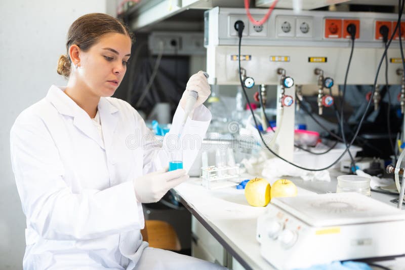 Efficient Female Lab Technician Working with Reagents in Test Tubes ...