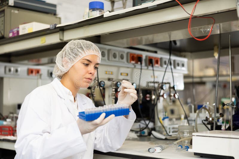 Efficient Female Lab Technician Working with Reagents in Test Tubes ...