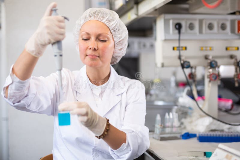 Efficient Female Lab Technician Working with Reagents in Test Tubes ...