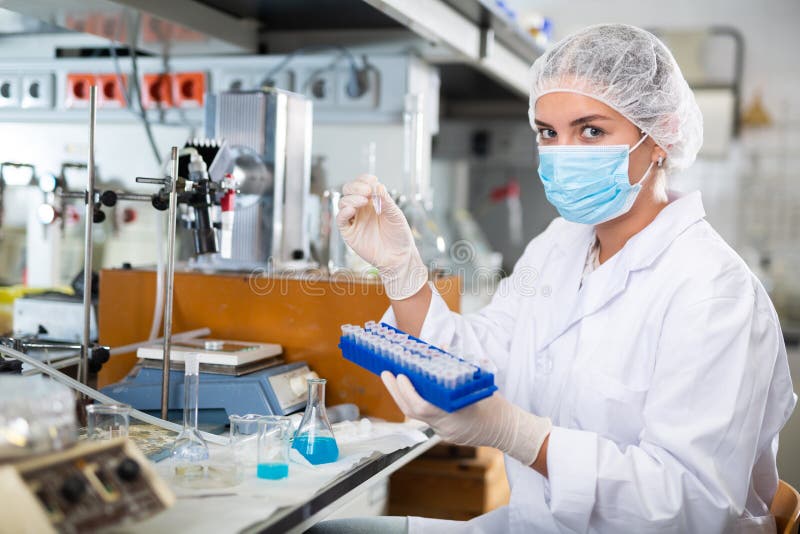 Efficient Female Lab Technician Working with Reagents in Test Tubes ...