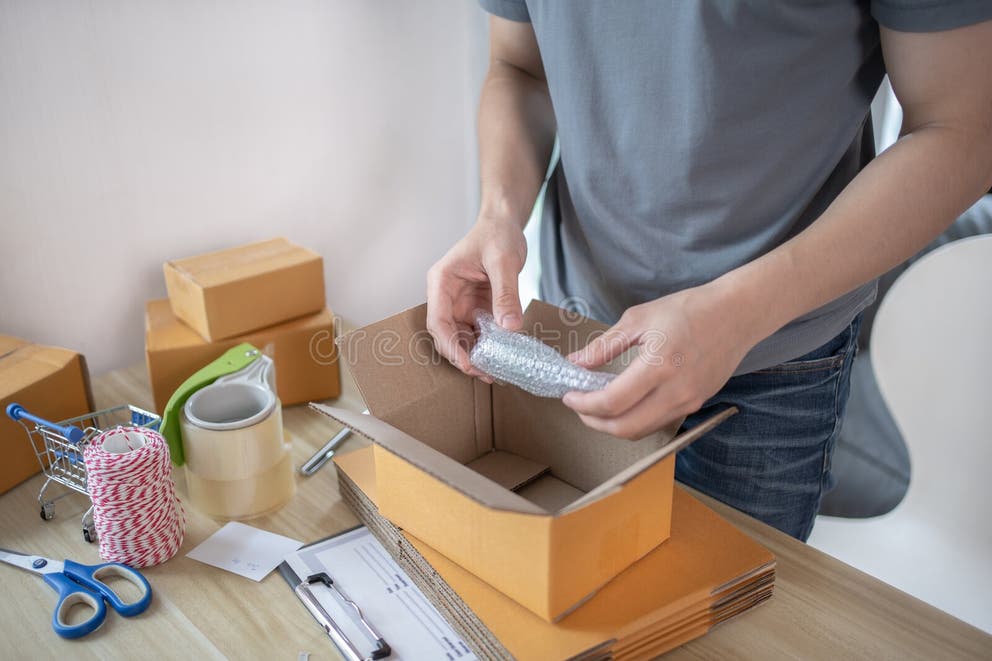 Efficient Home-Based Delivery, Man Packing Items into Post Box for ...