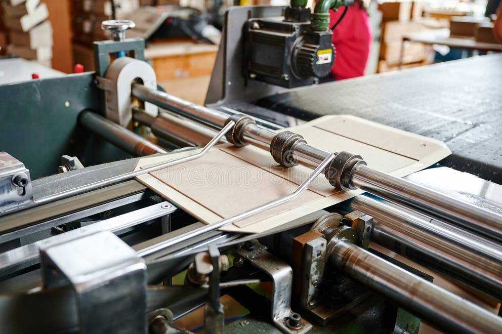 Efficient Machine Folding Cardboard Flaps in a Bustling Packaging ...