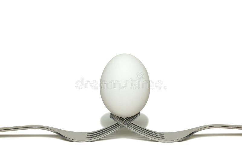 Egg Balanced on Two Forks stock image. Image of balance - 265776683