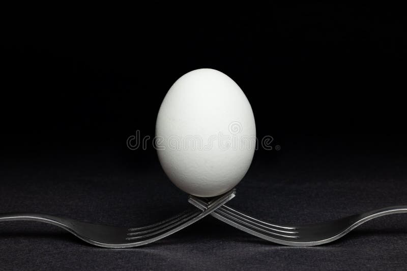 Egg Balanced on Two Forks stock image. Image of natural - 266391749
