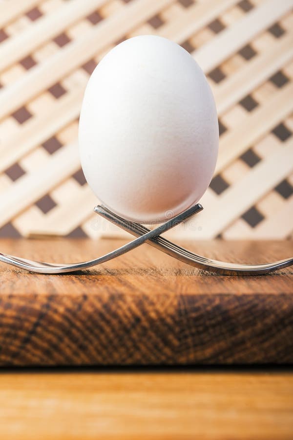 Egg balancing by two forks stock image. Image of food - 48823733