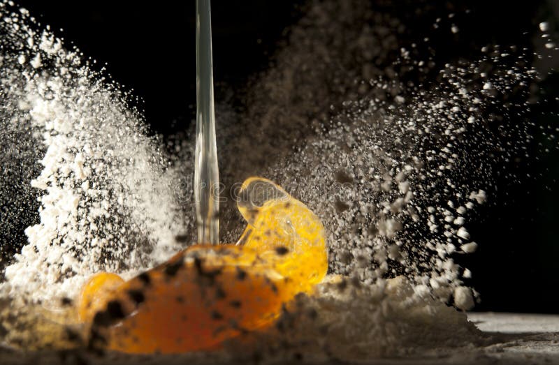 Egg being dropped in flour stock photo. Image of bread - 17923394