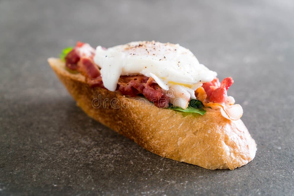 Egg Benedict with Bacon and Rocket Stock Photo - Image of plate ...