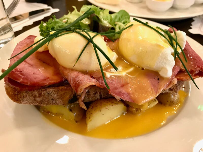 Egg Benedict with Roast Beef, Potatoes and Chives Served at Restaurant ...