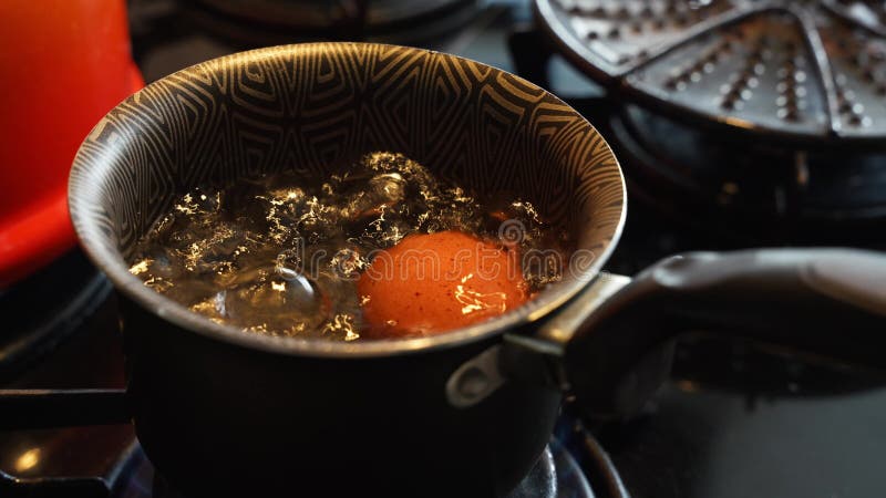 Egg Boiling in a Pot on a Lit Stove with Bubbling Water Stock Video ...