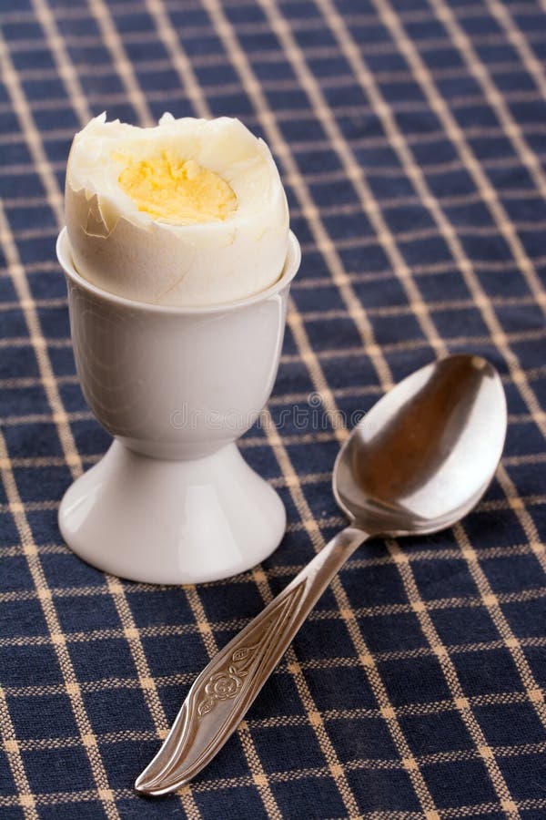 Egg Cup with an Egg on Top of a Dark Blue Table Cloth Stock Image ...
