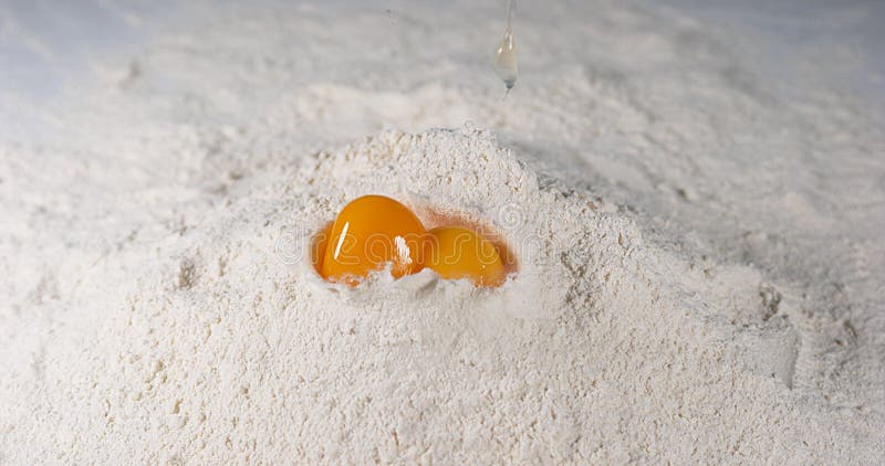 Egg Falling into Flour Against White Background Stock Photo - Image of ...