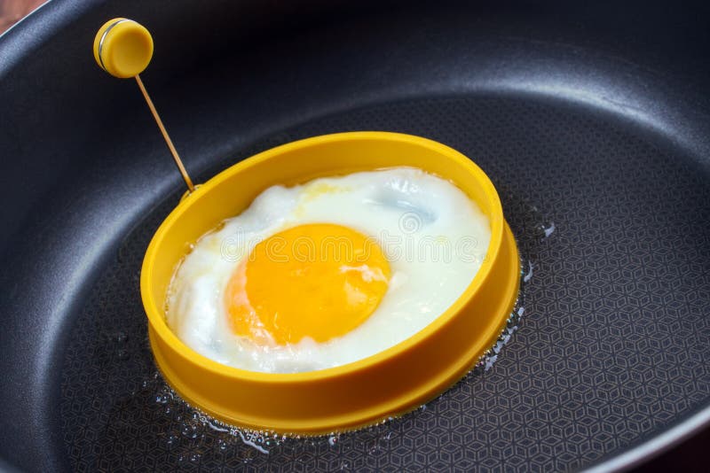 Egg fry form in use stock image. Image of closeup, yolk - 33370115