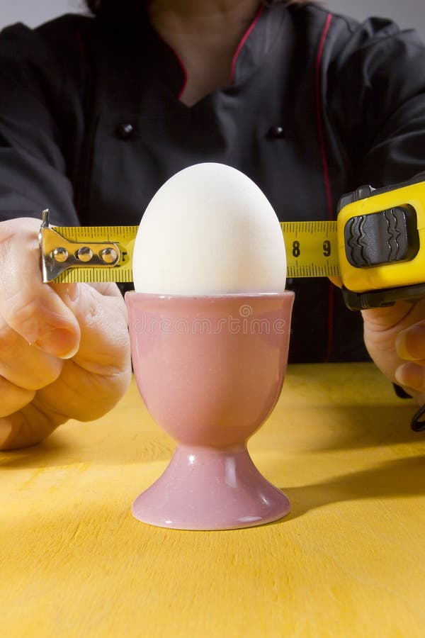 Egg in Holder and Hands with Tape Measure Stock Photo - Image of meter ...