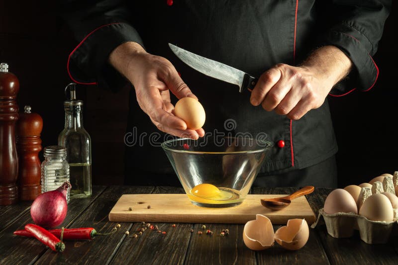 Egg and Knife in the Hands of the Chef before Breaking. Cooking a ...