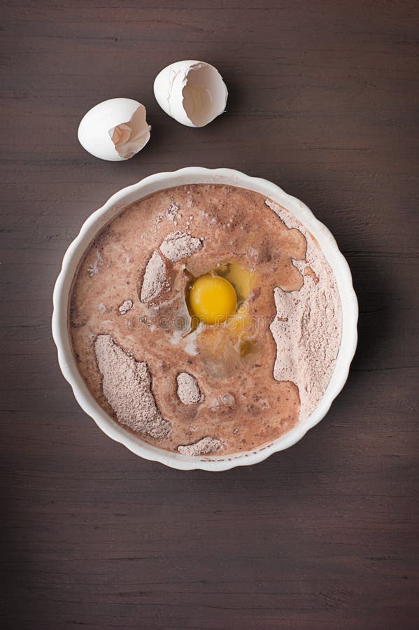 Egg Mixture for Baking and Shells on a Dark Wooden Background Stock ...