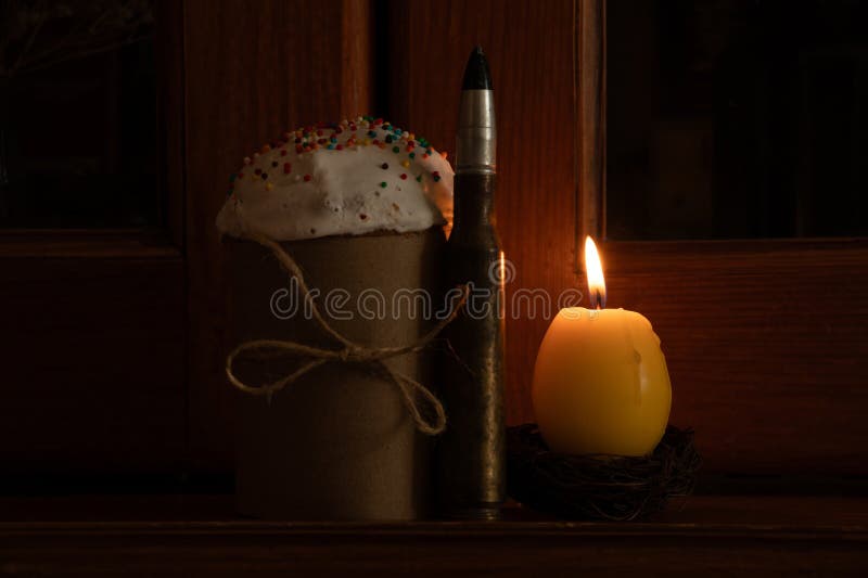 Egg-shaped Candle and Bullet and Next To it Stands an Easter Cake on a ...