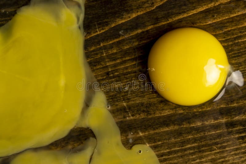 Egg Smashed on a Black Table, a Broken Cracked Chicken Egg Spreads on a ...