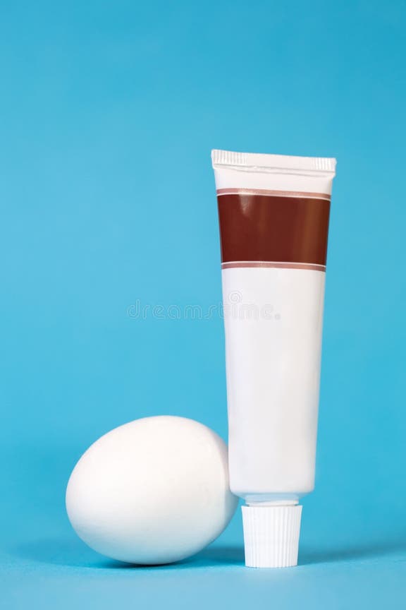 An Egg and a Tube of Toothpaste without a Logo on a Blue Background ...