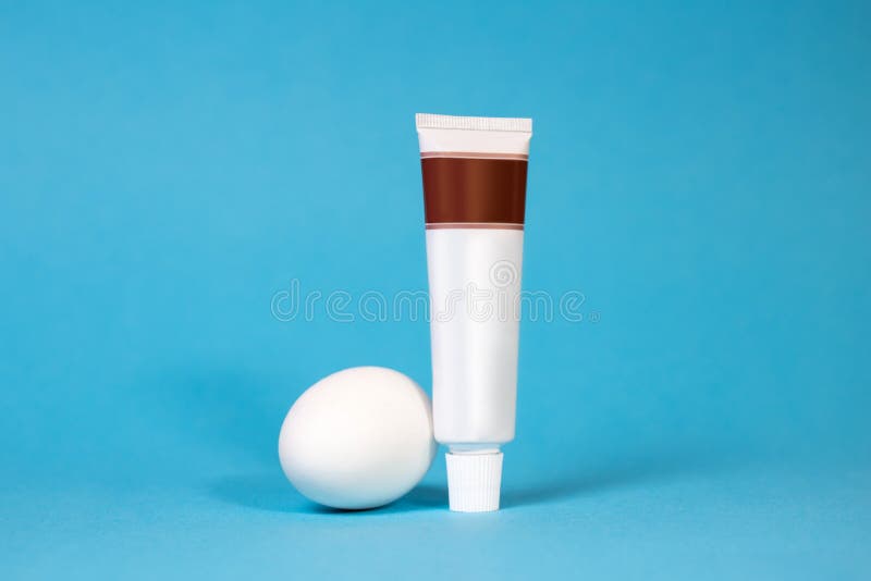 An Egg and a Tube of Toothpaste without a Logo on a Blue Background ...