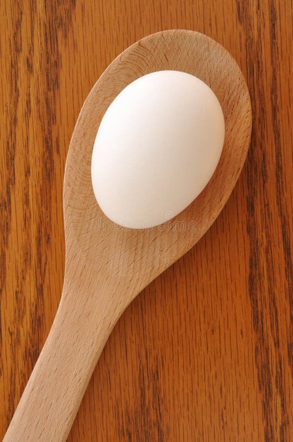 Egg on a Wooden Spoon stock image. Image of copy, space - 13025013