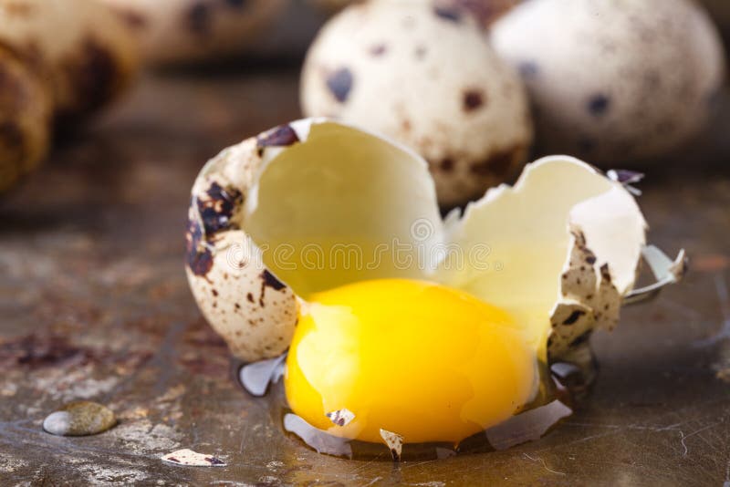 Egg Yolk in Brocken Quail Eggs on Rustic Table Stock Photo - Image of ...